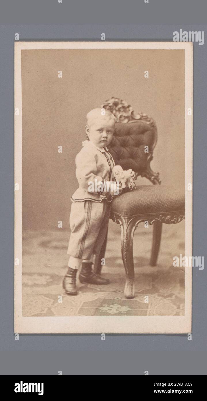 Portrait of an unknown boy, standing next to a chair, August Roesler ...