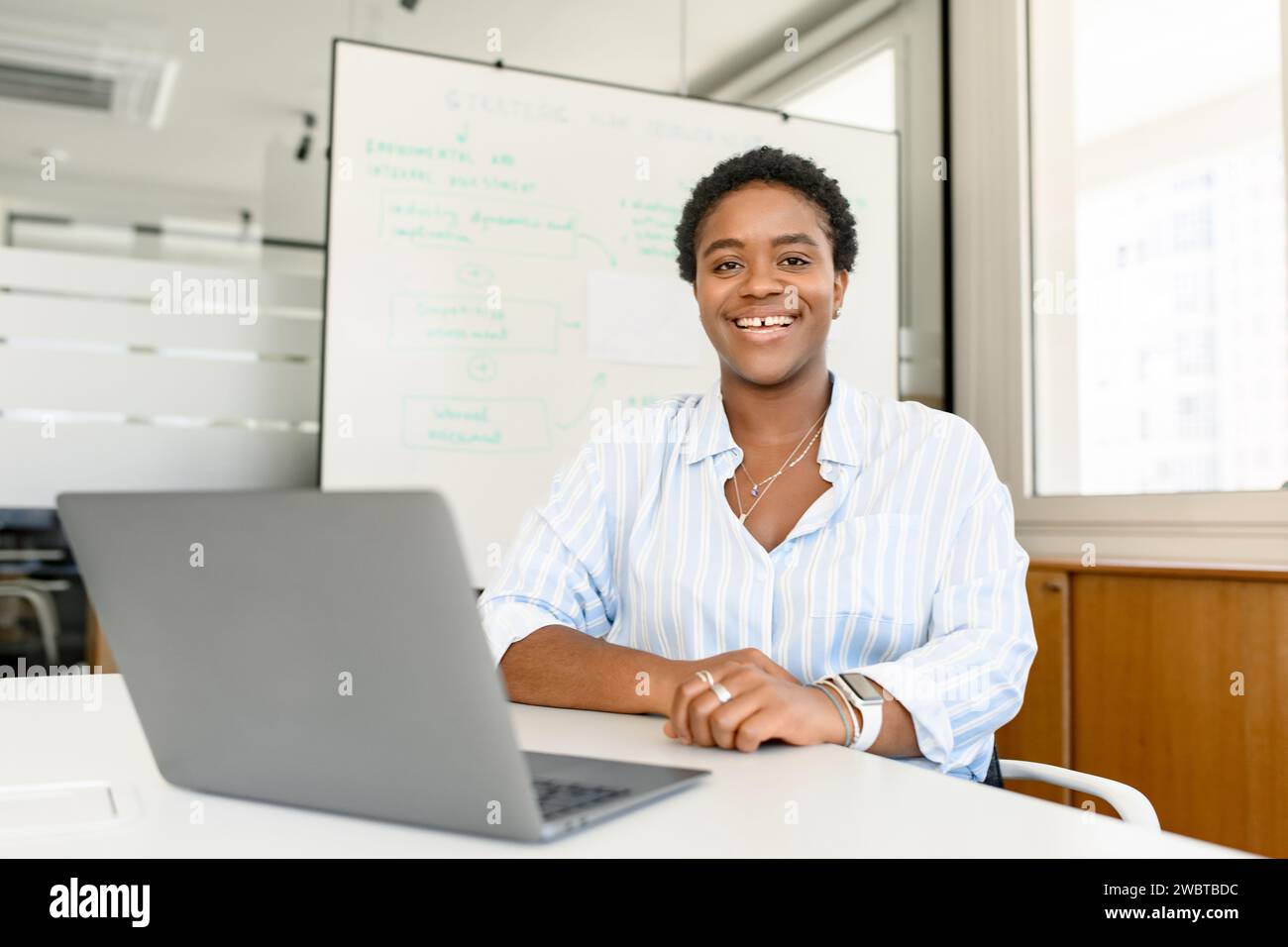 Headshot of friendly and positive African-American woman with short ...
