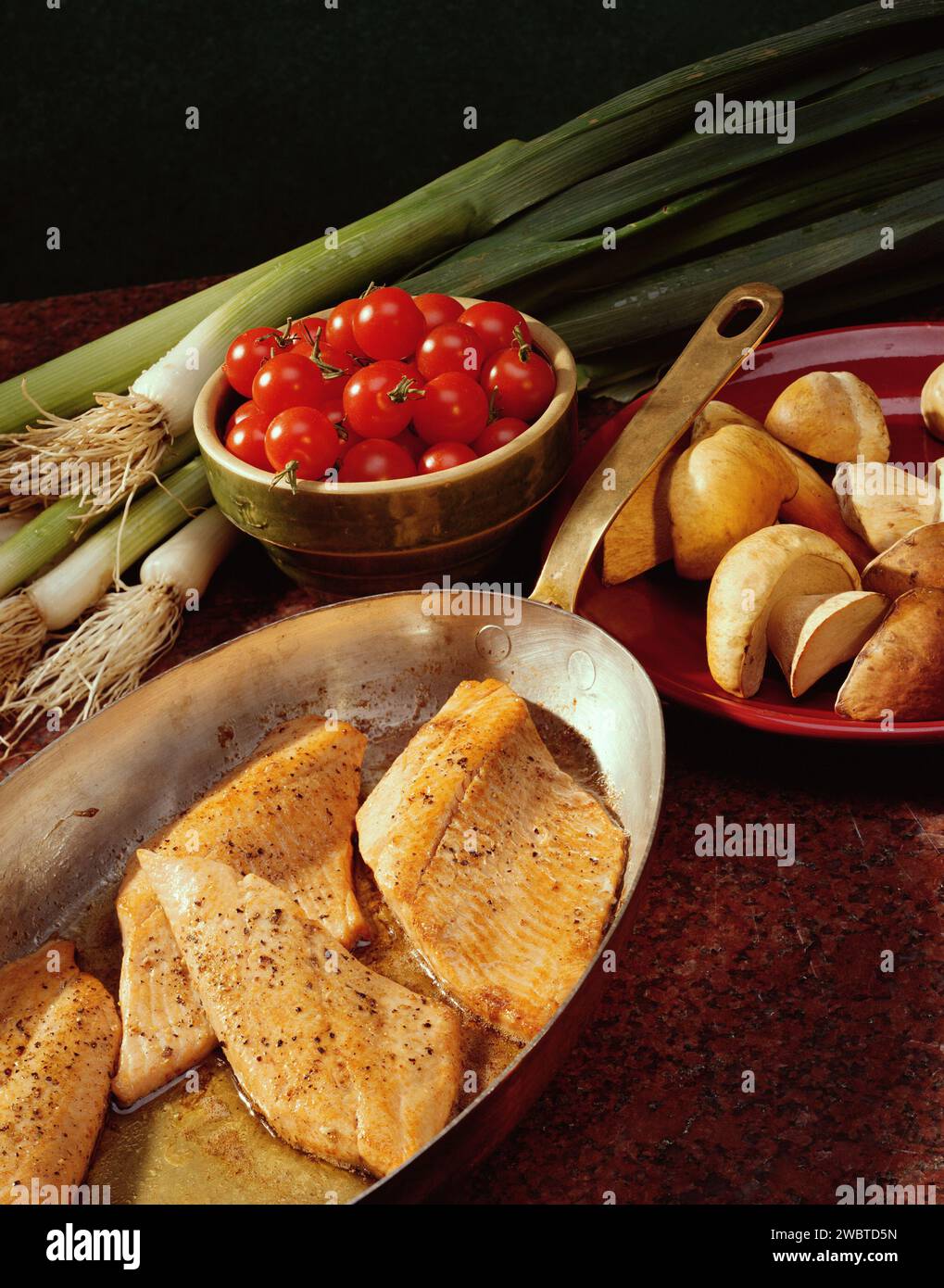 Fish Fillet Cooked in Pan with tomato and mushrooms - Side view Stock ...