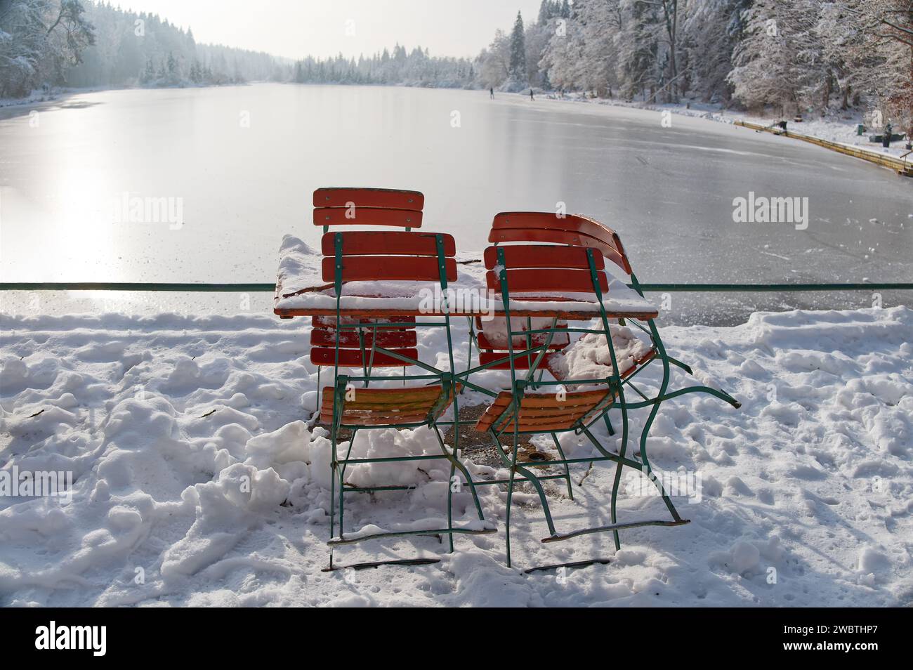 Table and chairs of a restaurant in a snowed winter landscape and low ...
