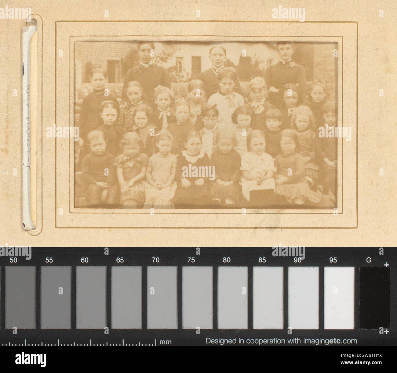 Group portrait of a class of girls and boys with three teachers ...