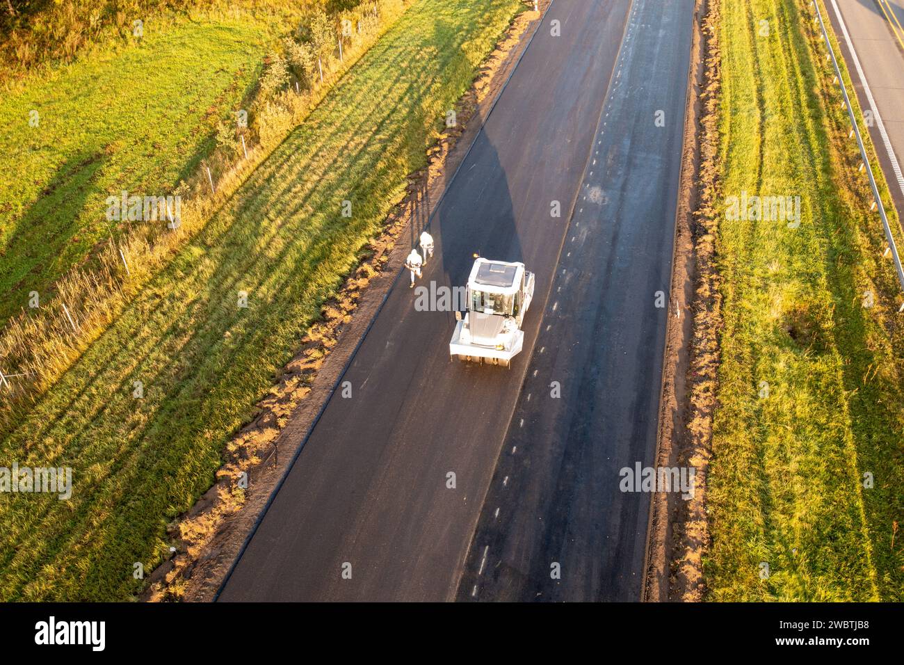 Drone photography of highway repair with heavy industrial machinery ...