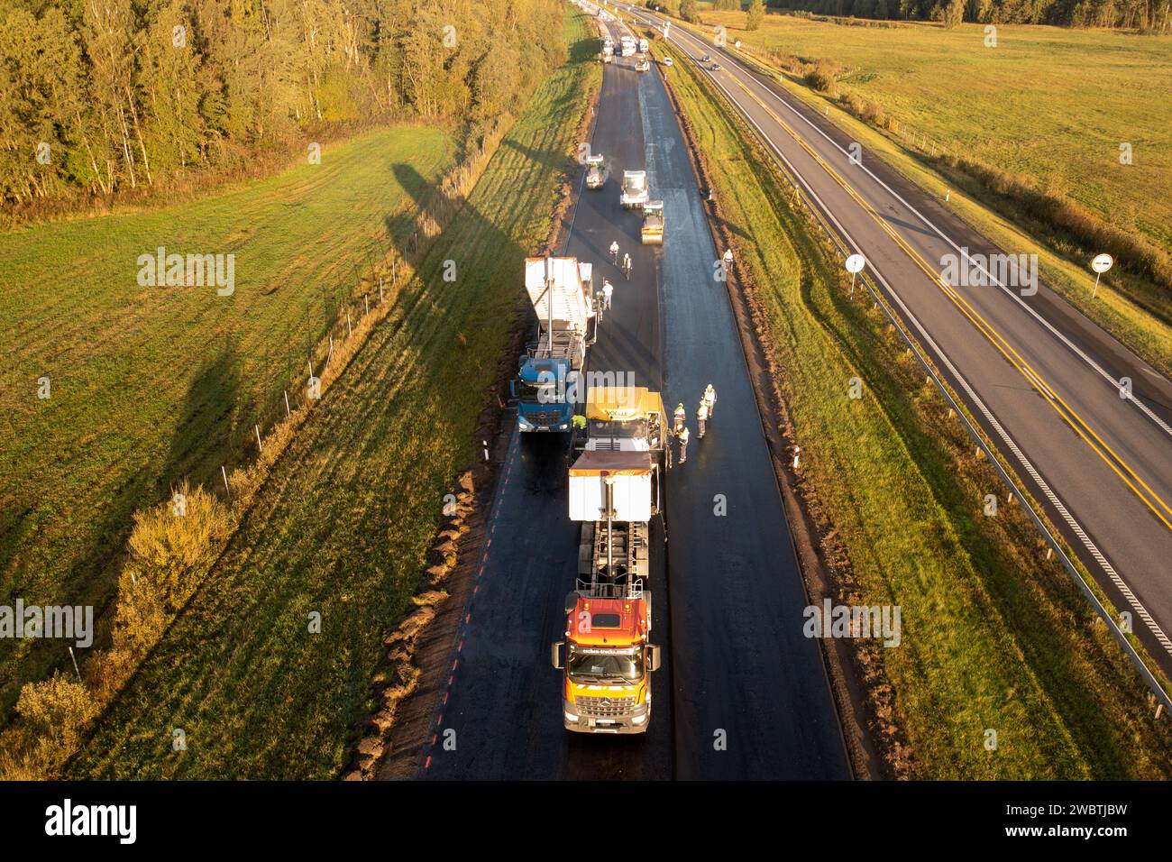 Drone photography of highway repair with heavy industrial machinery ...