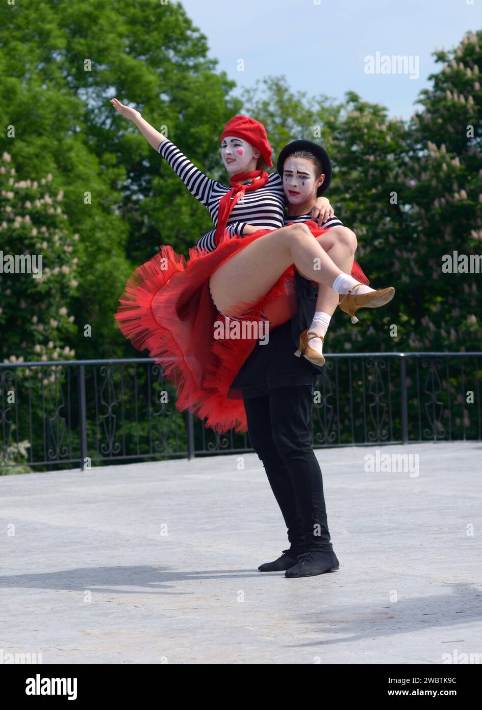 Young people dancing wearing in clowns costumes. Costume ball of high ...