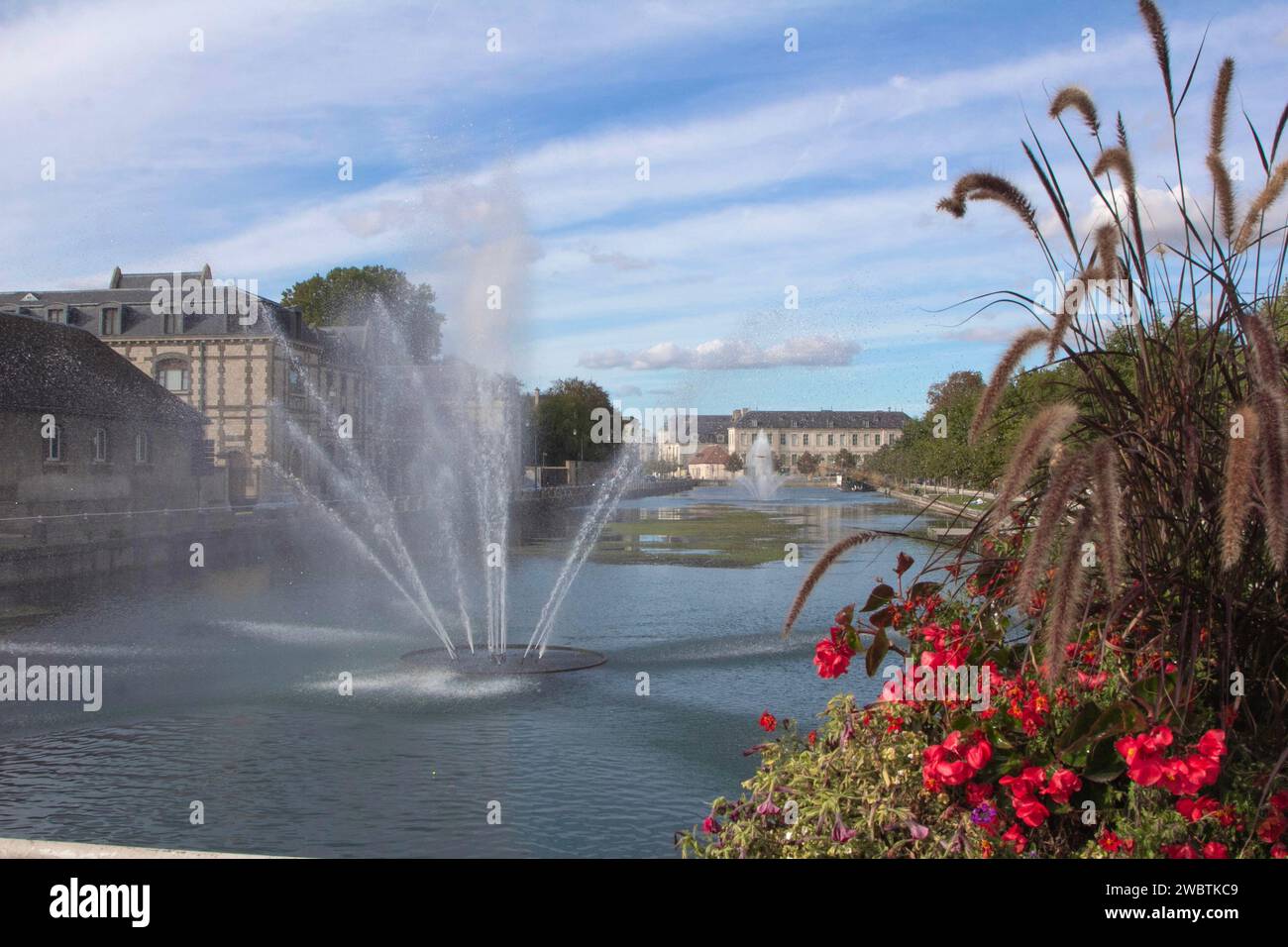 Fountains on the Canal des Trévois in the historic city centre of ...