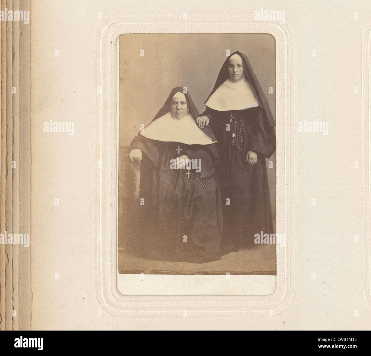 Portrait of two nuns, one of which is sitting and the other next to it ...