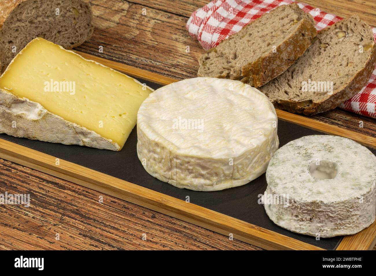 French cheese platter on a board, close-up Stock Photo - Alamy