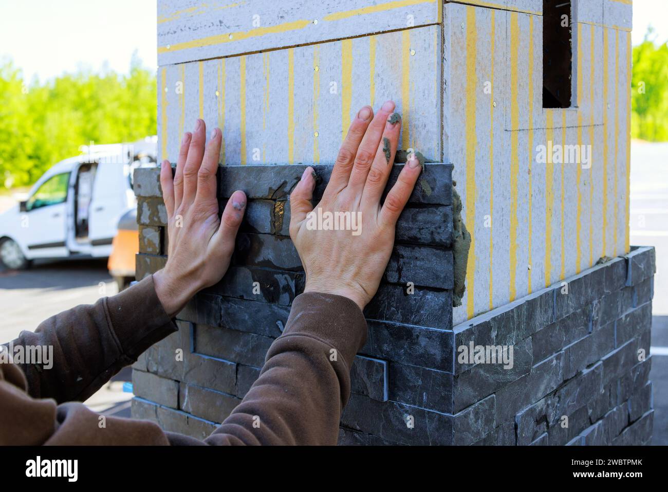 Building columns are faced with tiles installed by tiler Stock Photo ...