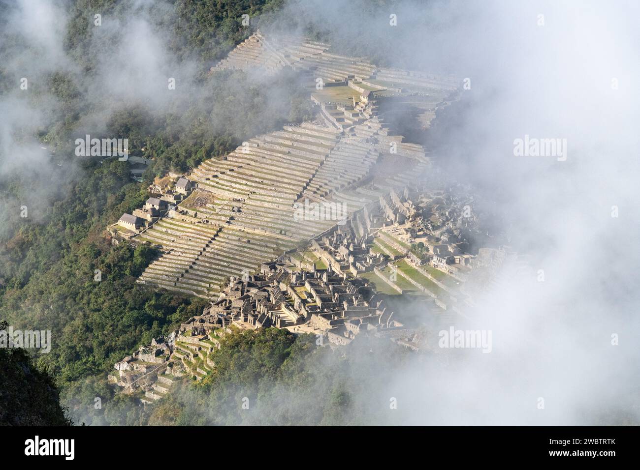 A cloudy and misty view of the Machu Picchu citadel ruins from Huayna ...