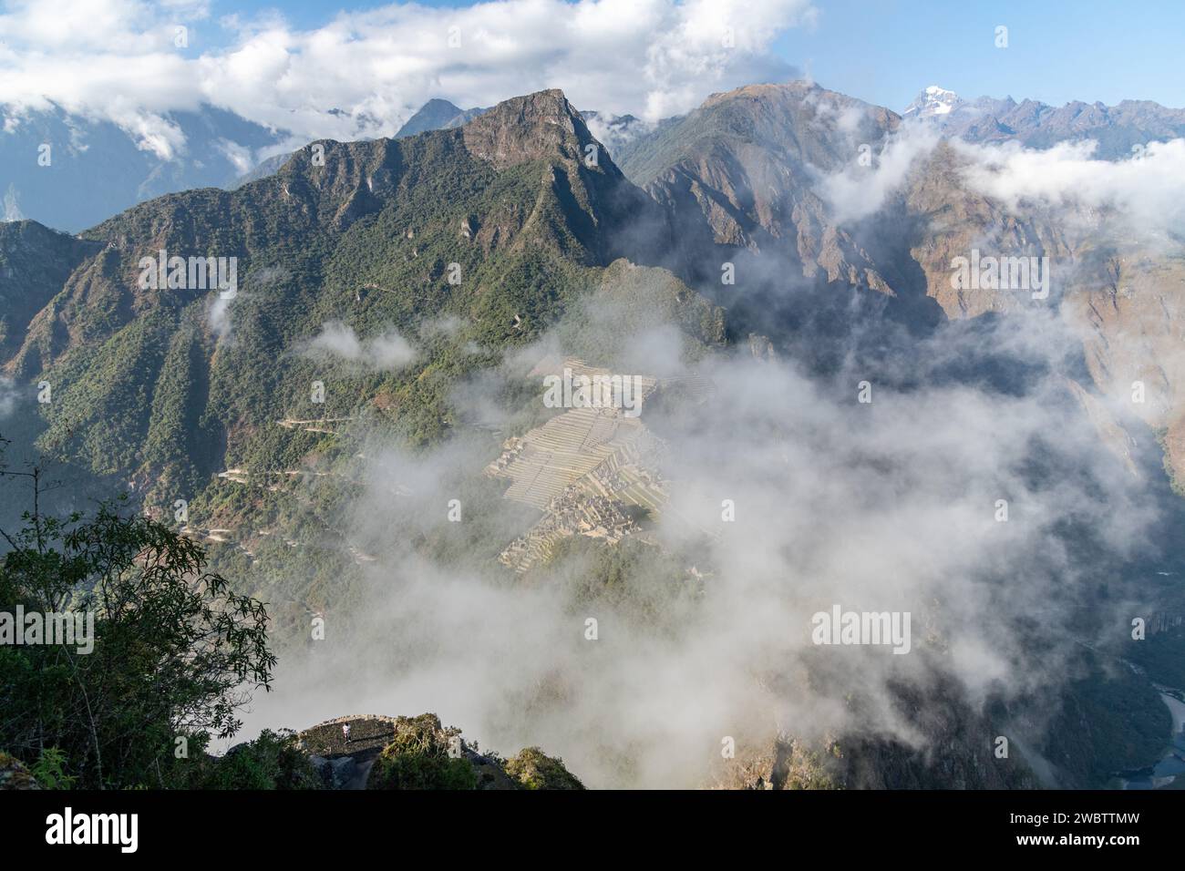 A cloudy and misty view of the Machu Picchu citadel ruins from Huayna ...