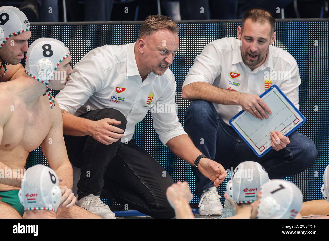 Zagreb, Croatia. 12th Jan, 2024. Head coach of Hungary Zsolt Varga talks with the players during ...