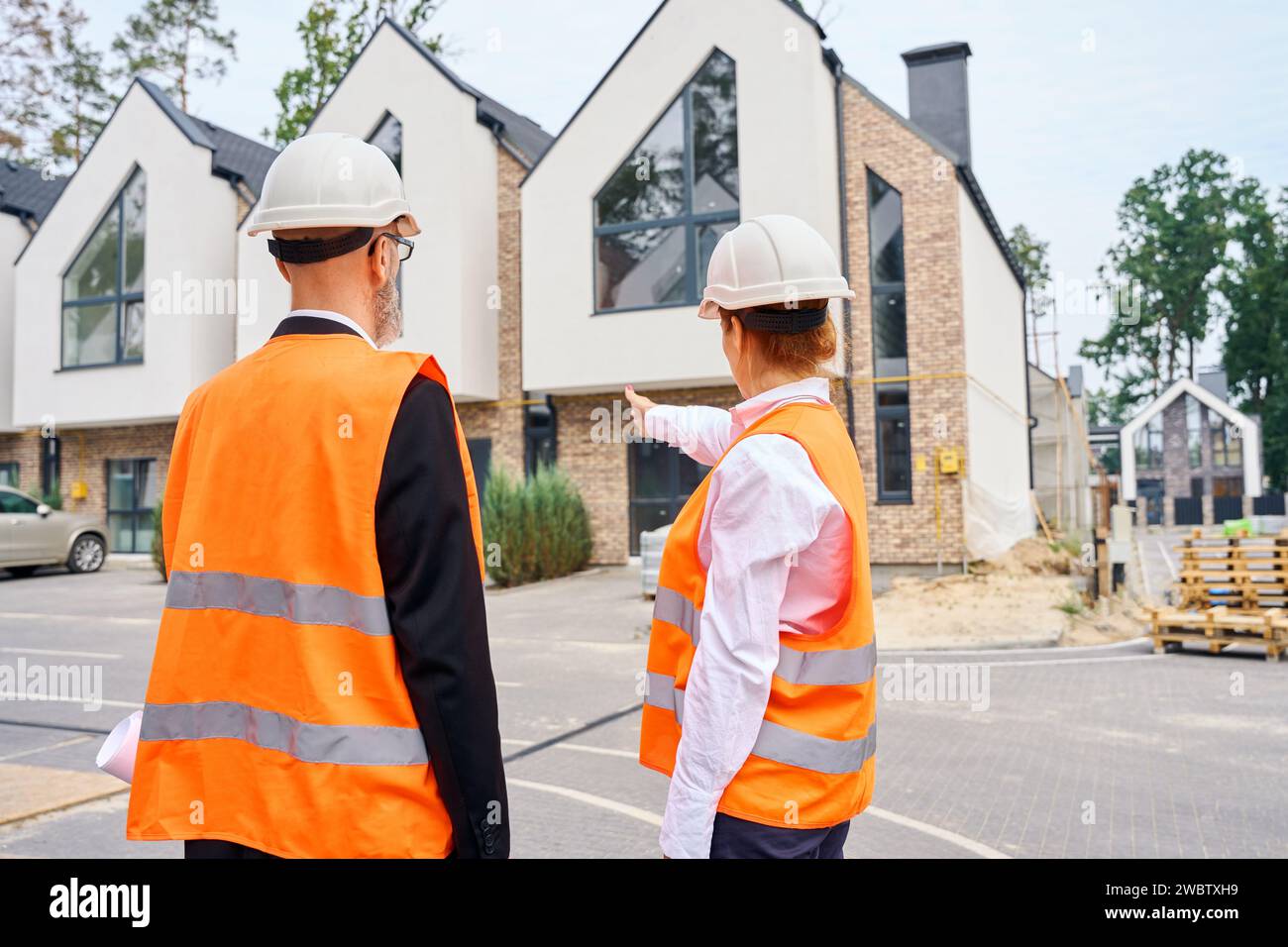 Construction manager and foreman inspecting development site together ...