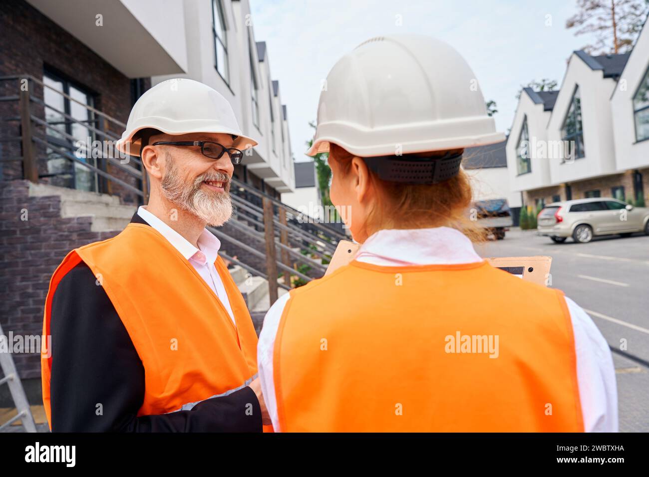Construction site manager demonstrating project documentation to her ...