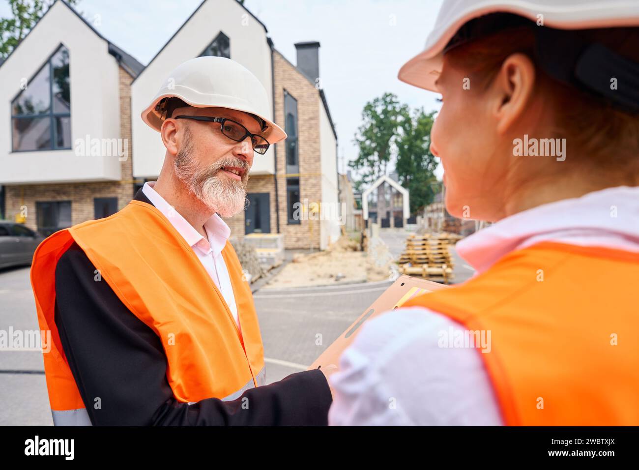 Construction personnel involved in discussion of building project ...