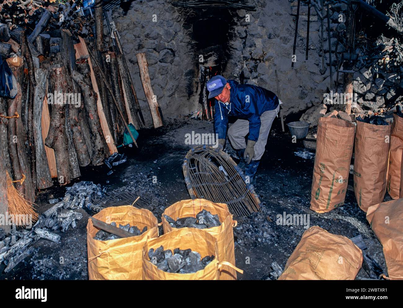 Charcoal preparation in Japan interior with fire and bags of charcoal ...