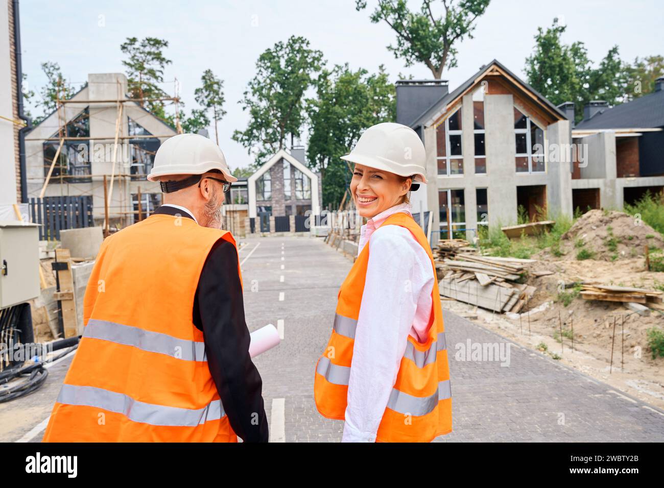 Joyous construction manager and contractor inspecting development site ...
