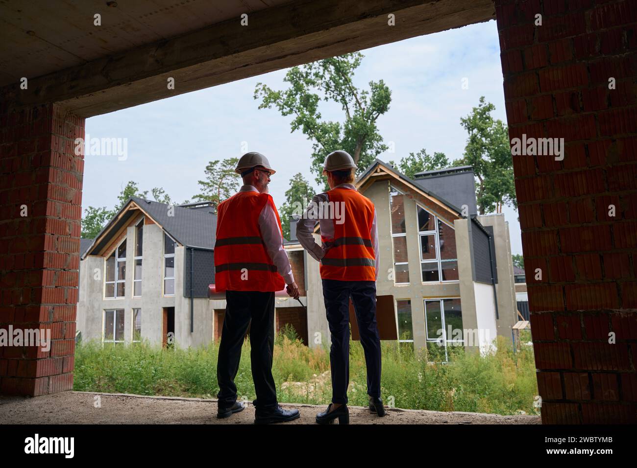 Foreman and construction supervisor conducting visual inspection of ...