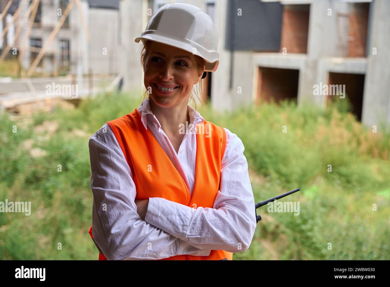 Joyous building inspector with handheld radio transceiver on ...
