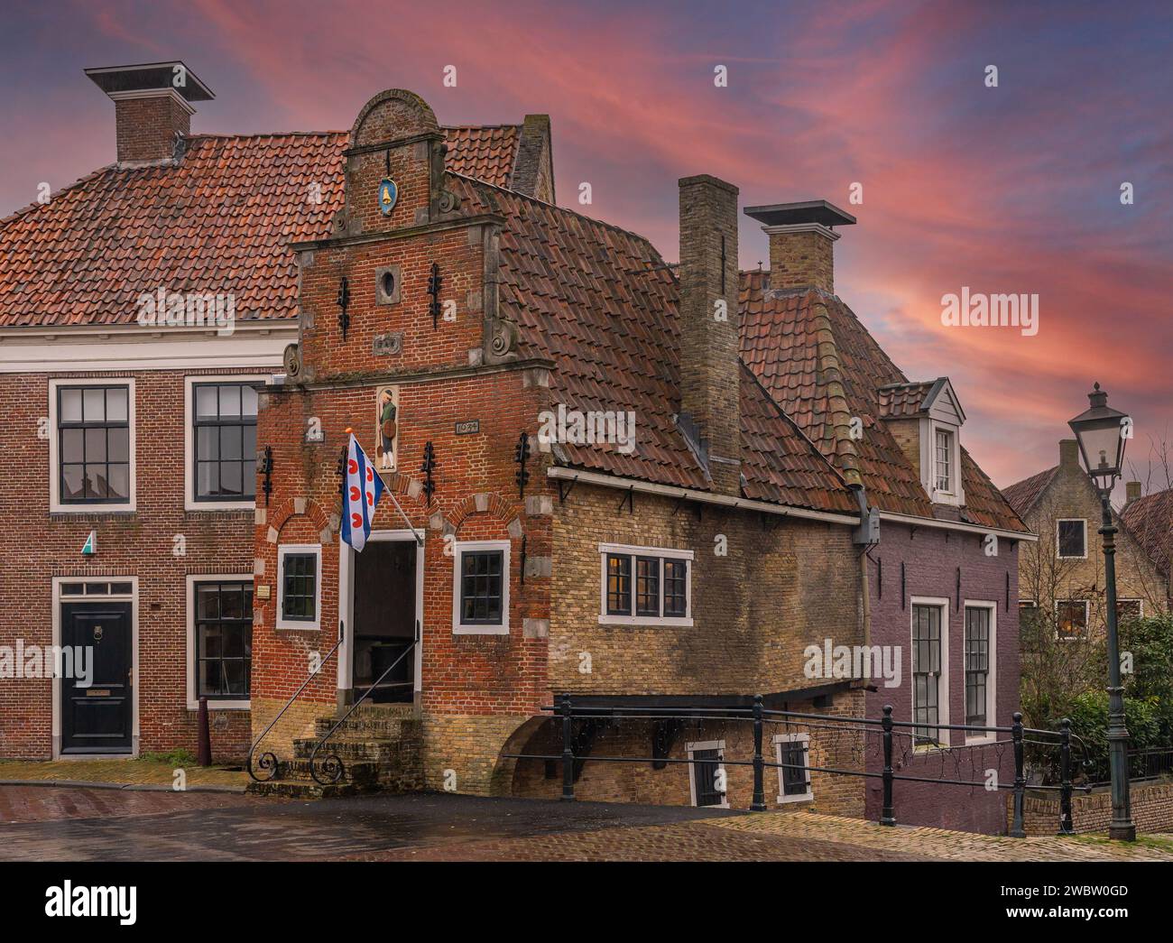 A historical house from 1634 known as Korendragershuisje with the flag ...