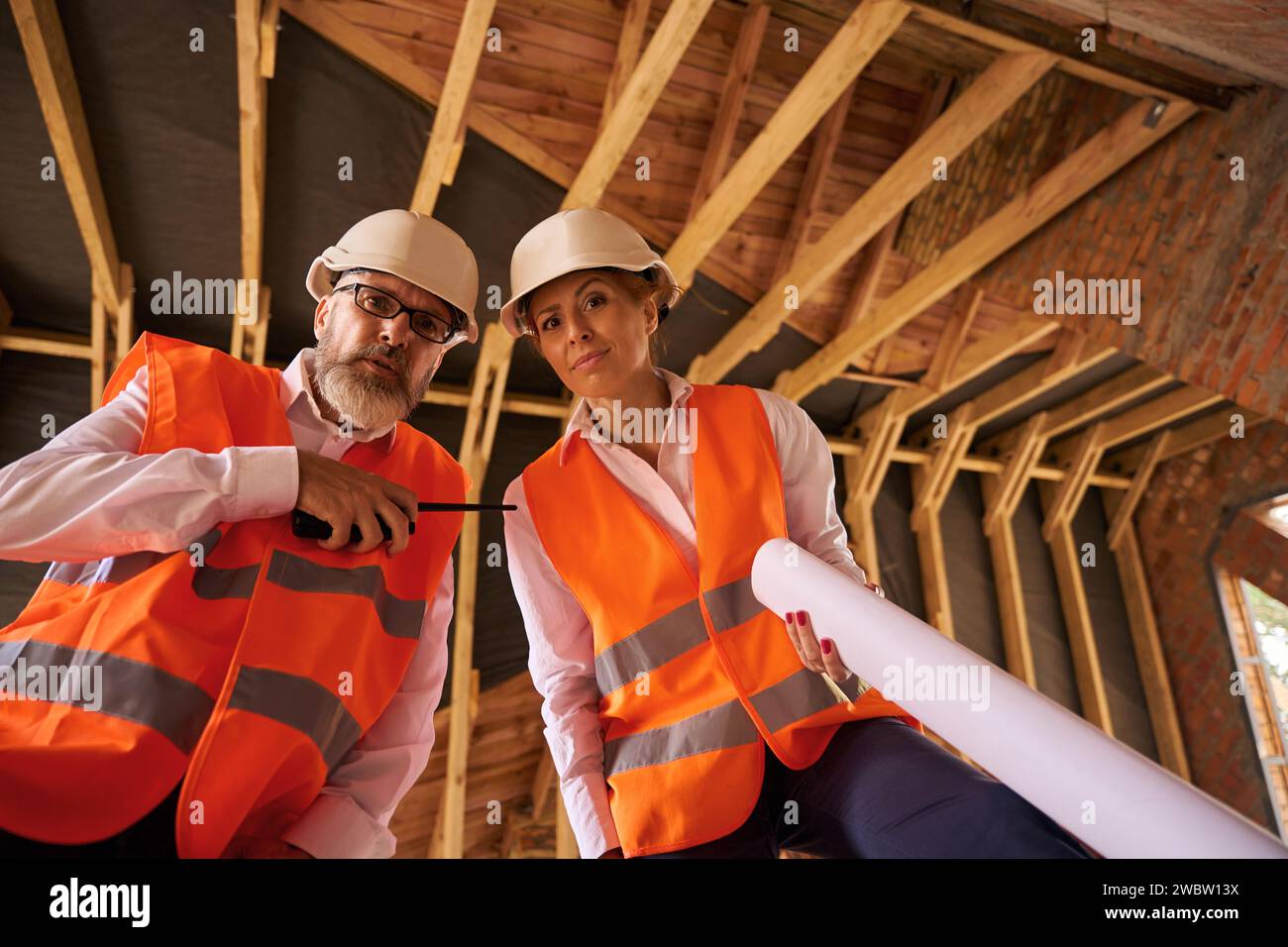 Contractor and building inspector posing for camera during home ...