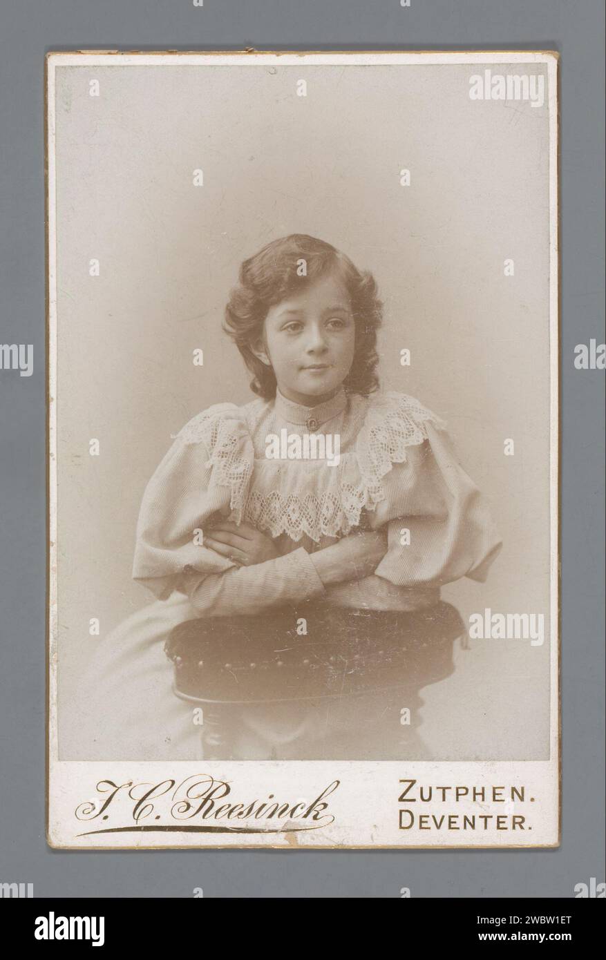 Studio portrait of an unknown girl in (presumably) her communion dress ...
