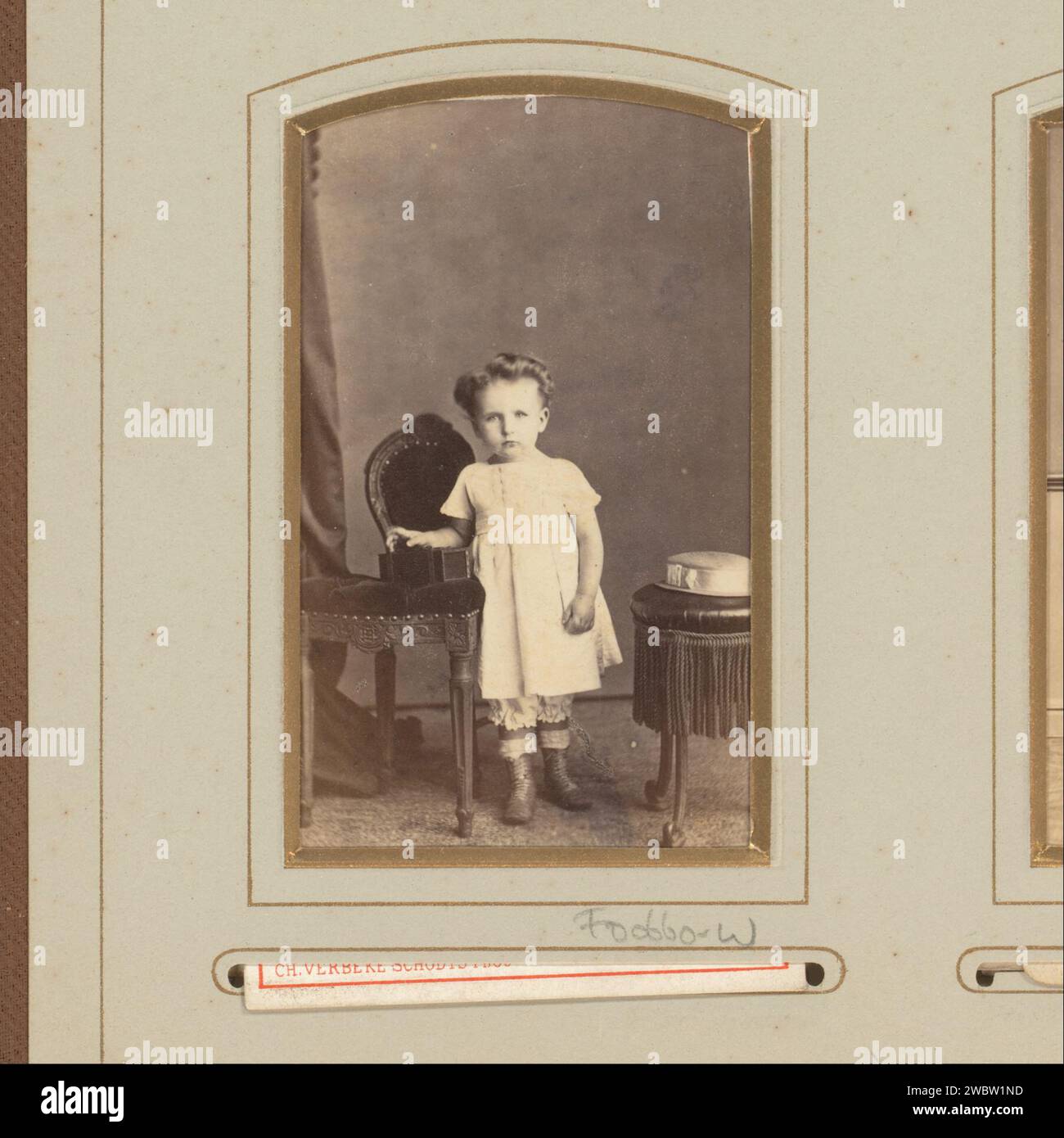 Portrait of a young girl at a chair with a photo camera, Ch. Verbeke ...