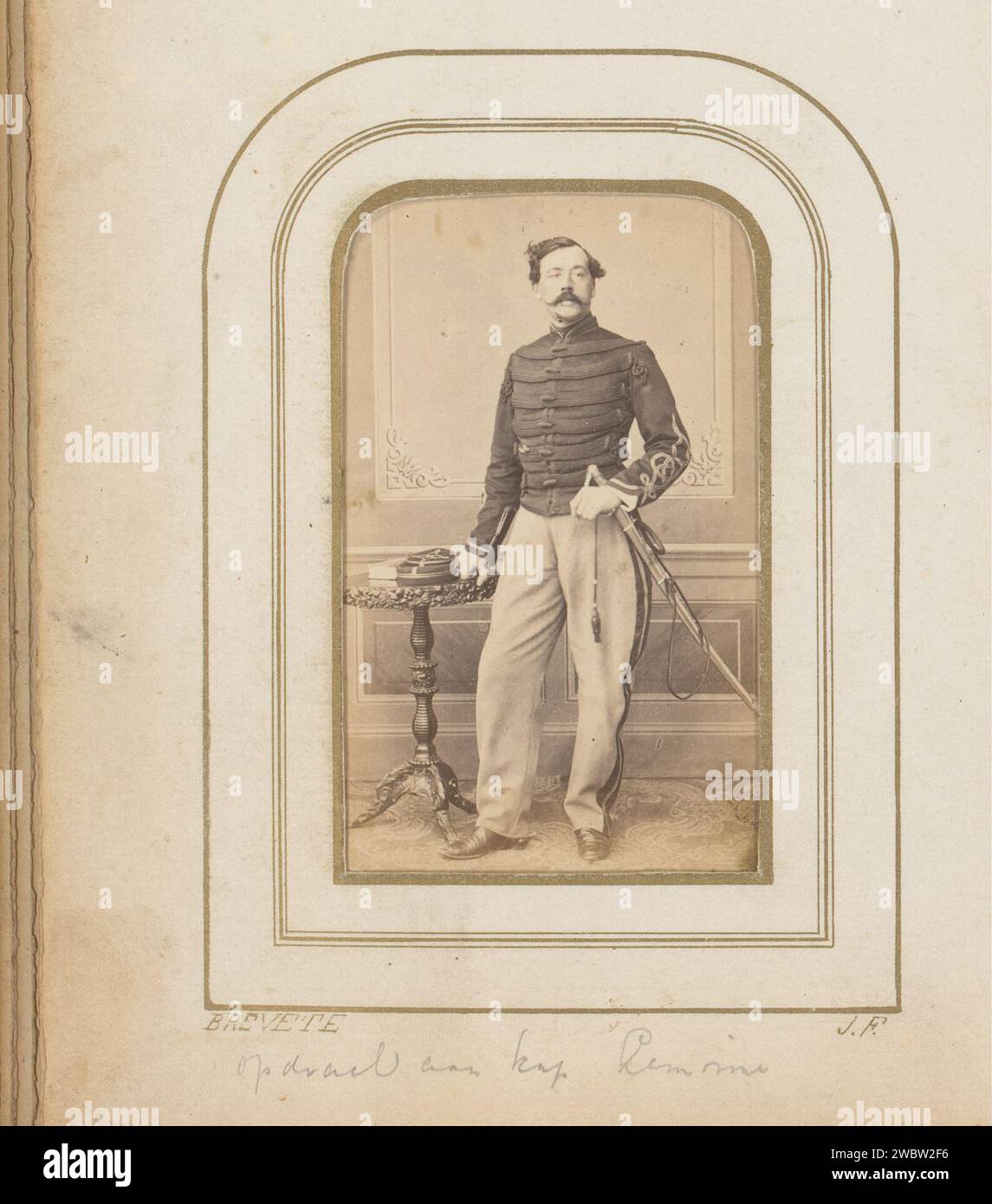 Portrait of a standing man in uniform with mustache and sword ...
