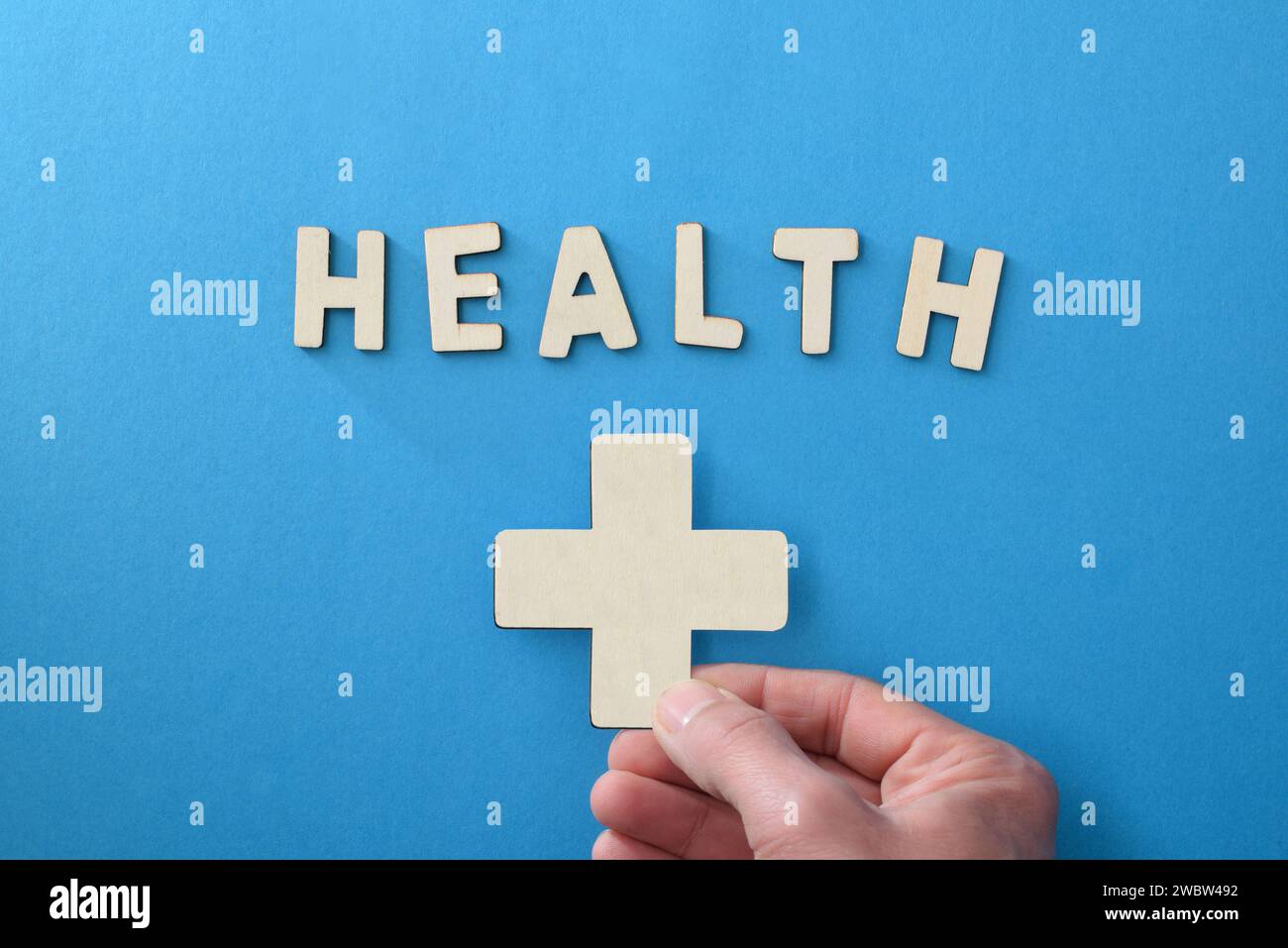 Background with cutouts of wooden letters forming the word health and ...
