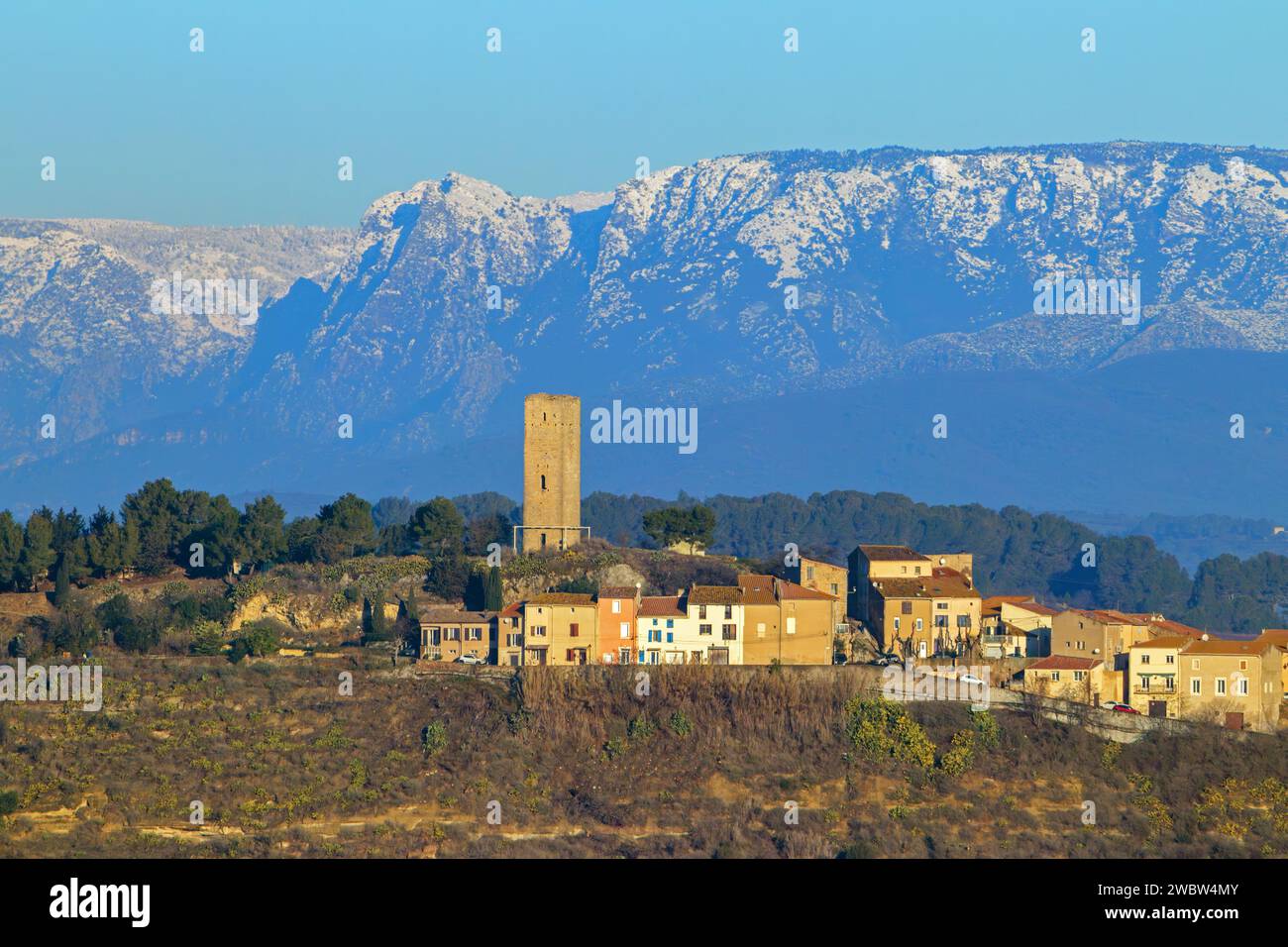 View of the village of Montady and the freshly snow-covered mountains ...