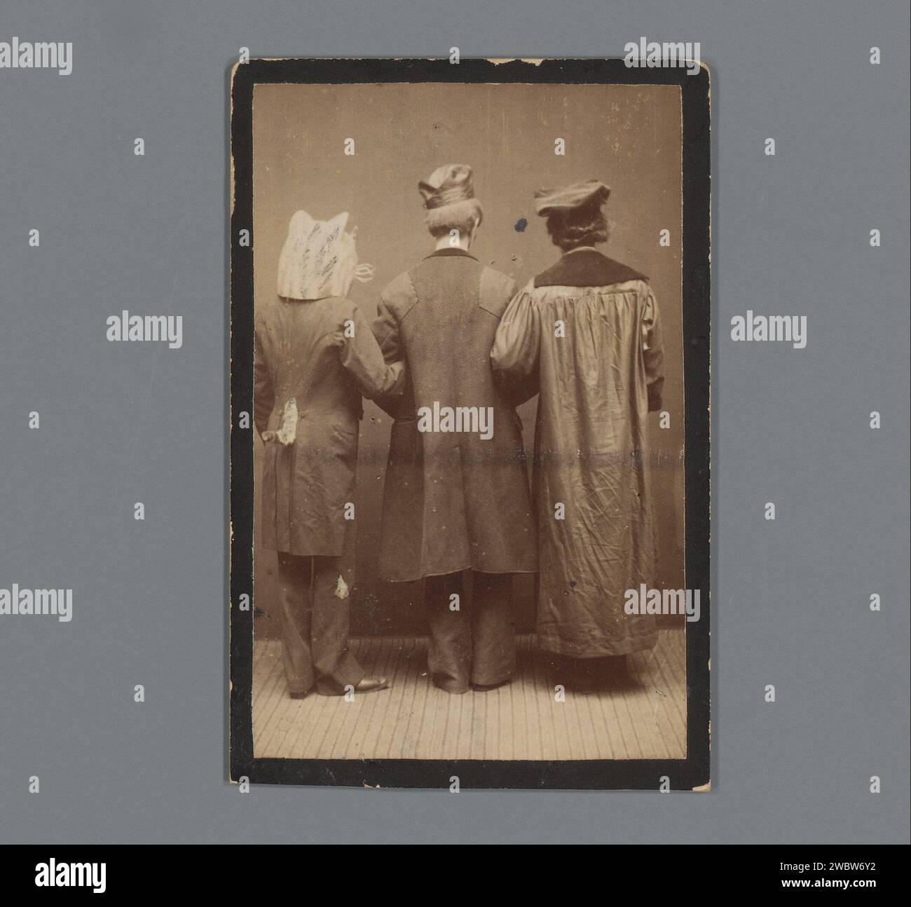 Portrait of three unknown costumed men with masks, seen from behind ...