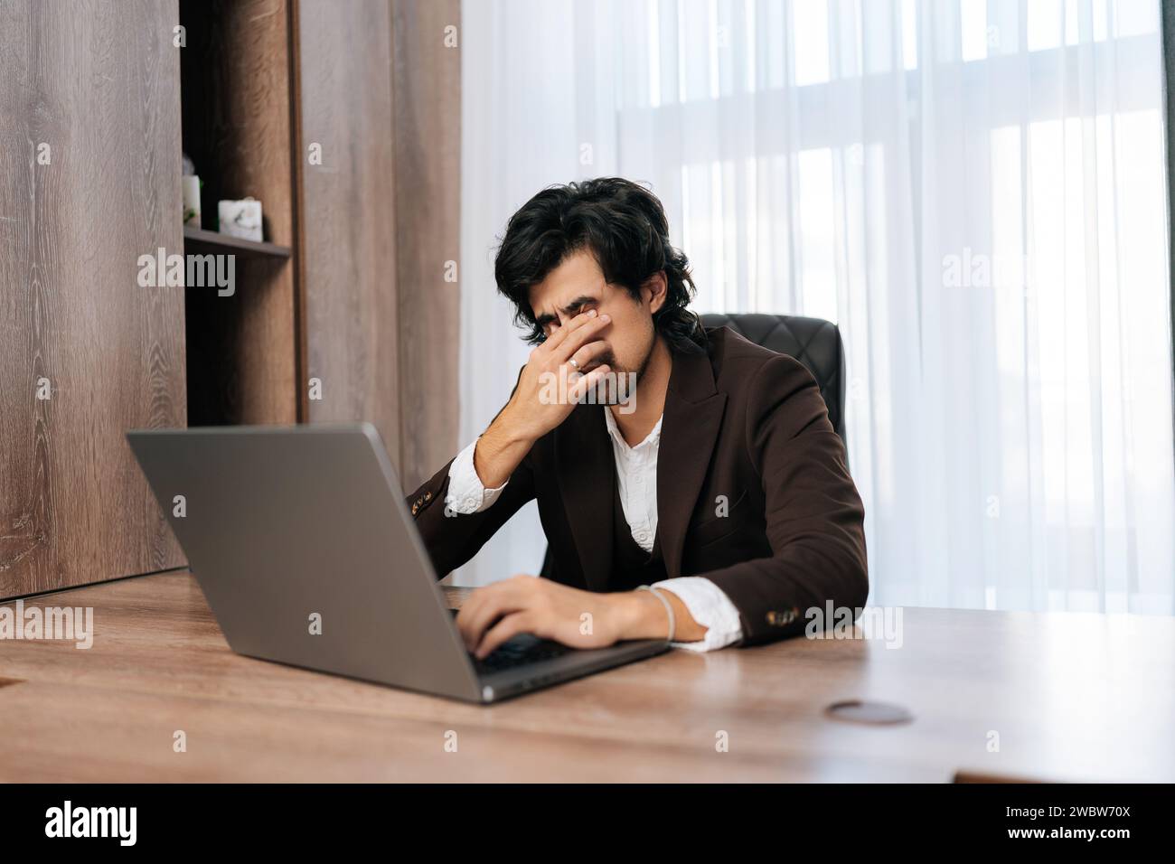 Tired overwhelmed businessman wearing suit working on computer ...