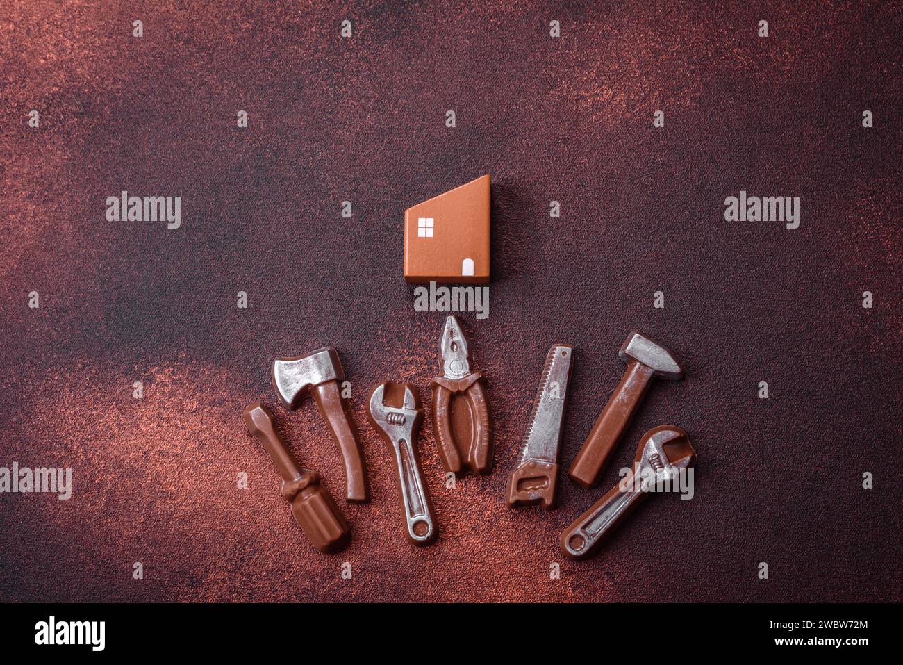 Repair or home improvement tools and a house model on a plain ...