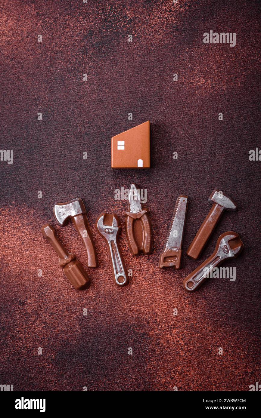 Repair or home improvement tools and a house model on a plain ...