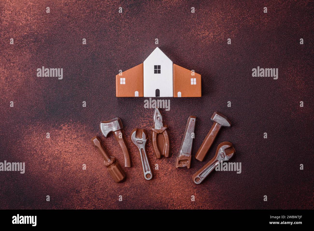 Repair or home improvement tools and a house model on a plain ...