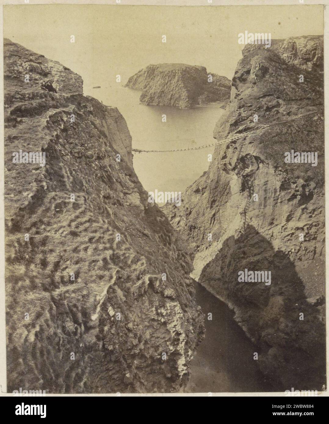 Rock formations on the English coast with a suspension bridge ...