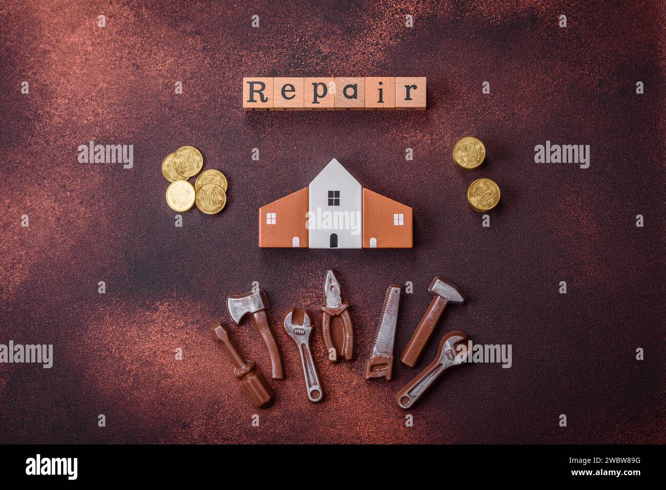 Repair or home improvement tools and a house model on a plain ...