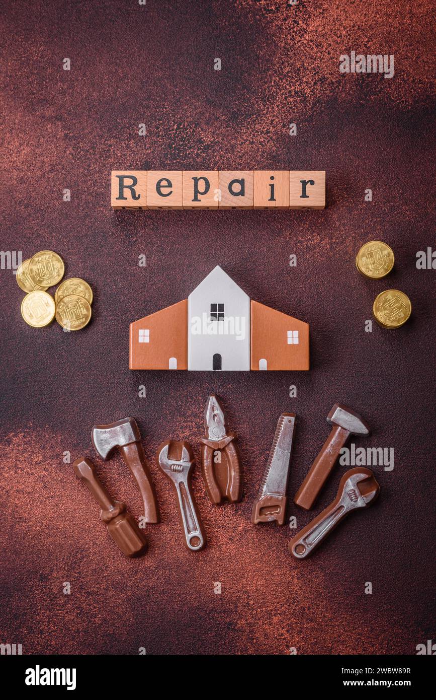 Repair or home improvement tools and a house model on a plain ...