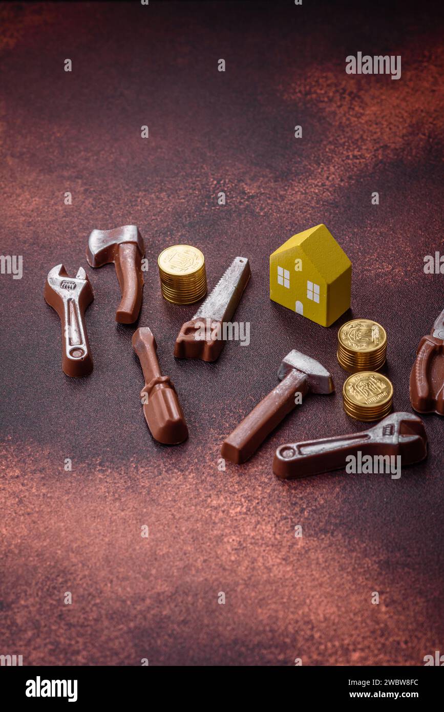 Repair or home improvement tools and a house model on a plain ...