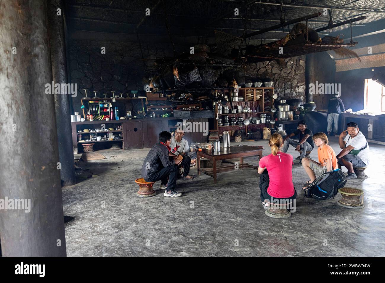 Tourists inside of chief house that is half on Indian, half on Myanmar ...