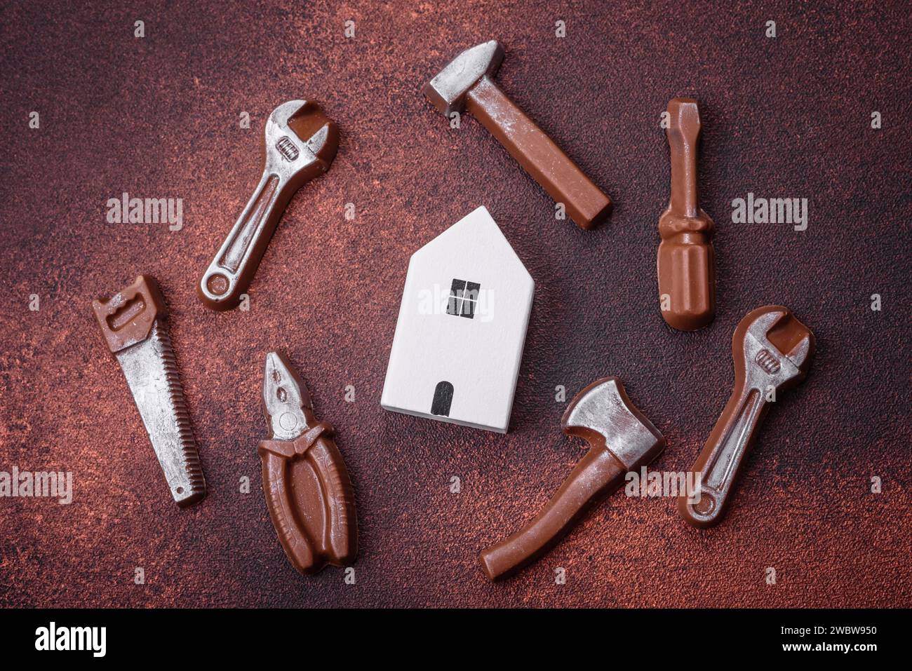 Repair or home improvement tools and a house model on a plain ...