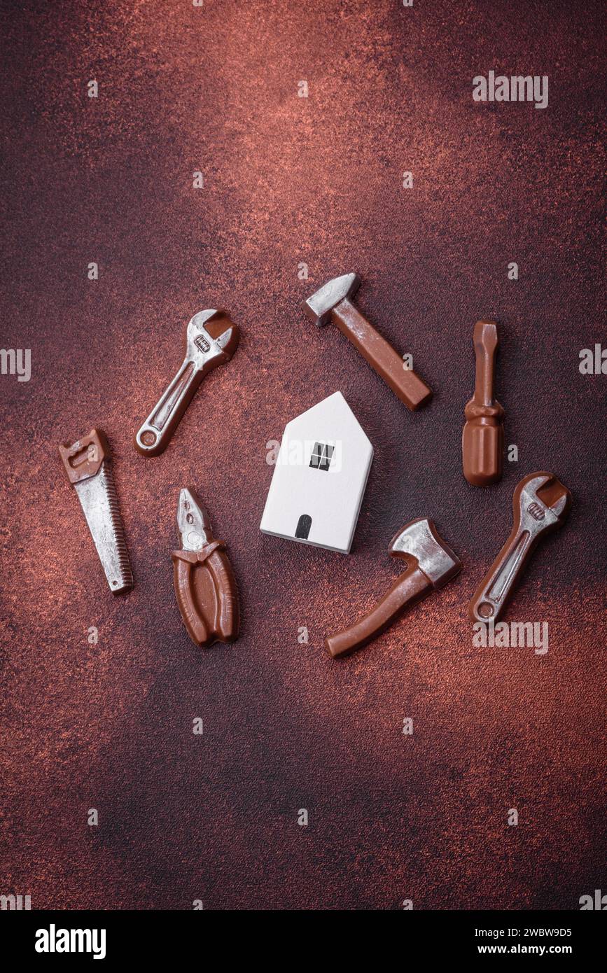 Repair or home improvement tools and a house model on a plain ...