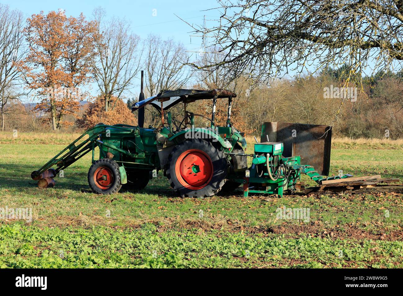 Tractor with a machine for splitting firewood Stock Photo - Alamy