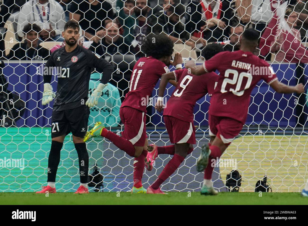 Qatar's Akram Afif, centre, celebrates after scoring his side's opening ...