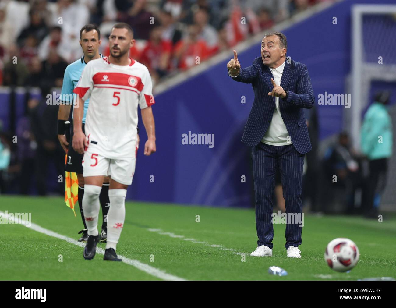 Lusail, Qatar. 12th Jan, 2024. Head coach Miodrag Radulovic (R) of ...