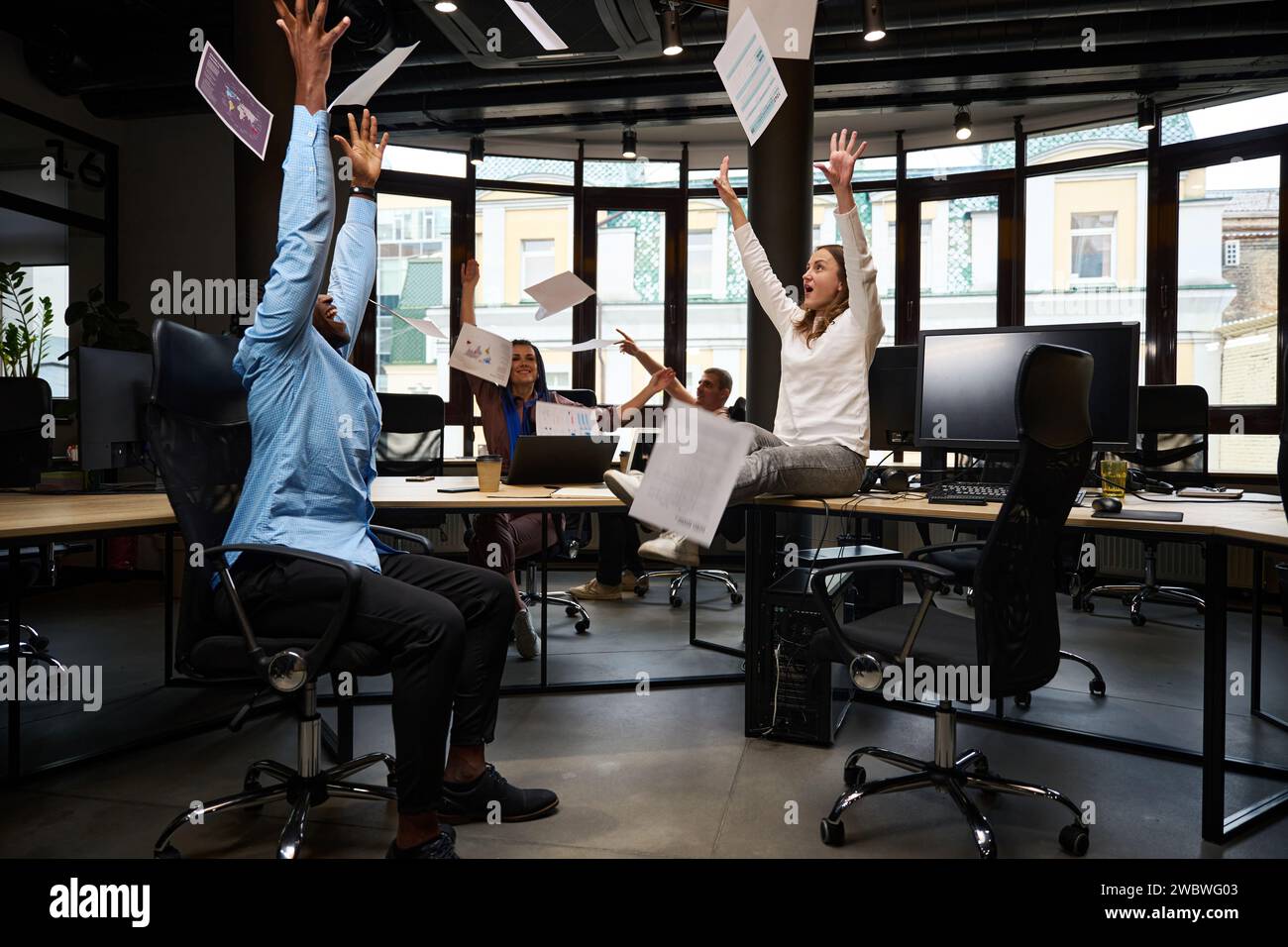 Cheerful colleagues celebrating successful project completion Stock ... Cheerful colleagues celebrating successful project completion Stock ...
