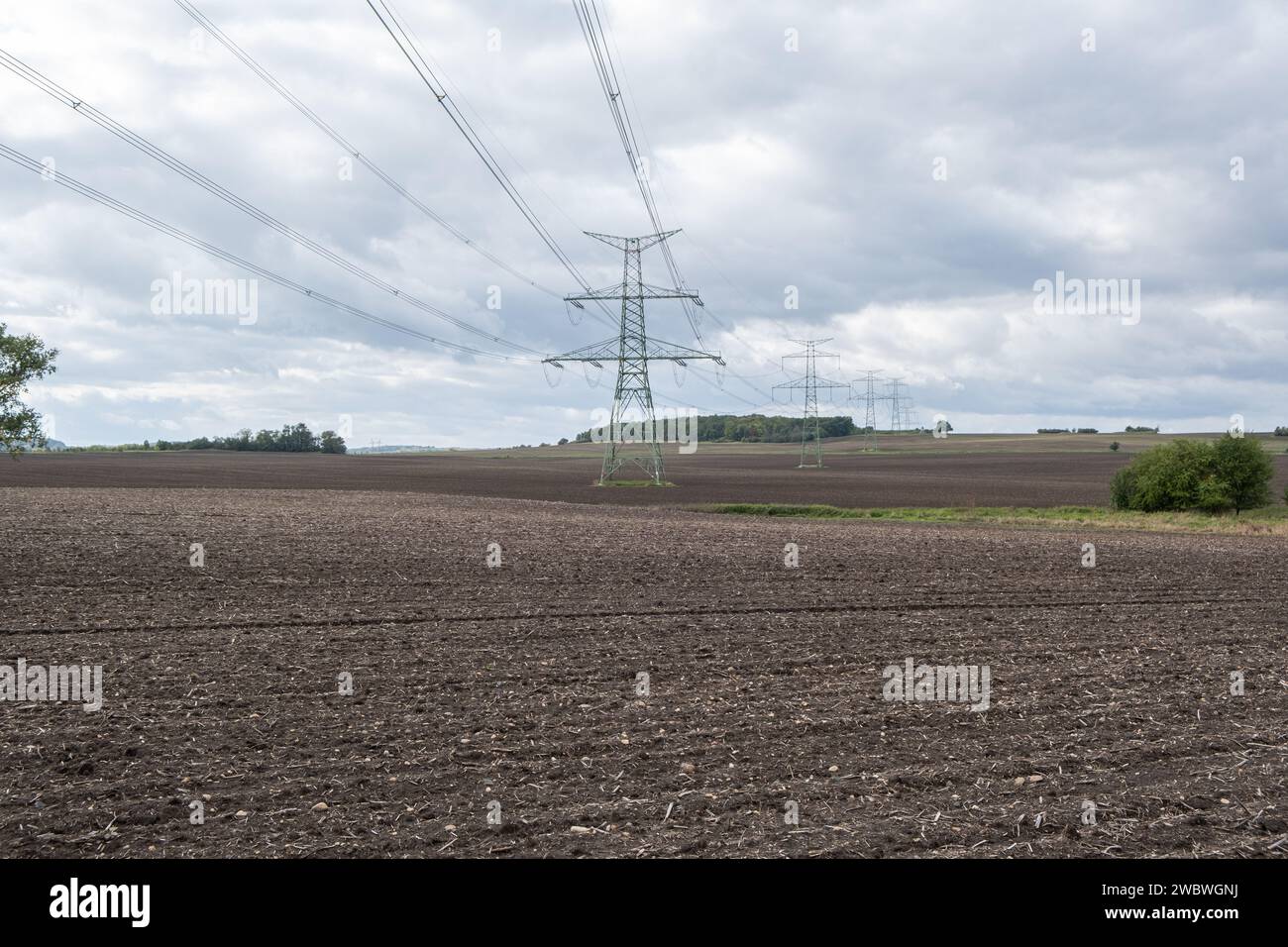 Towering electrical cable pylons with high-voltage power lines stretch ...