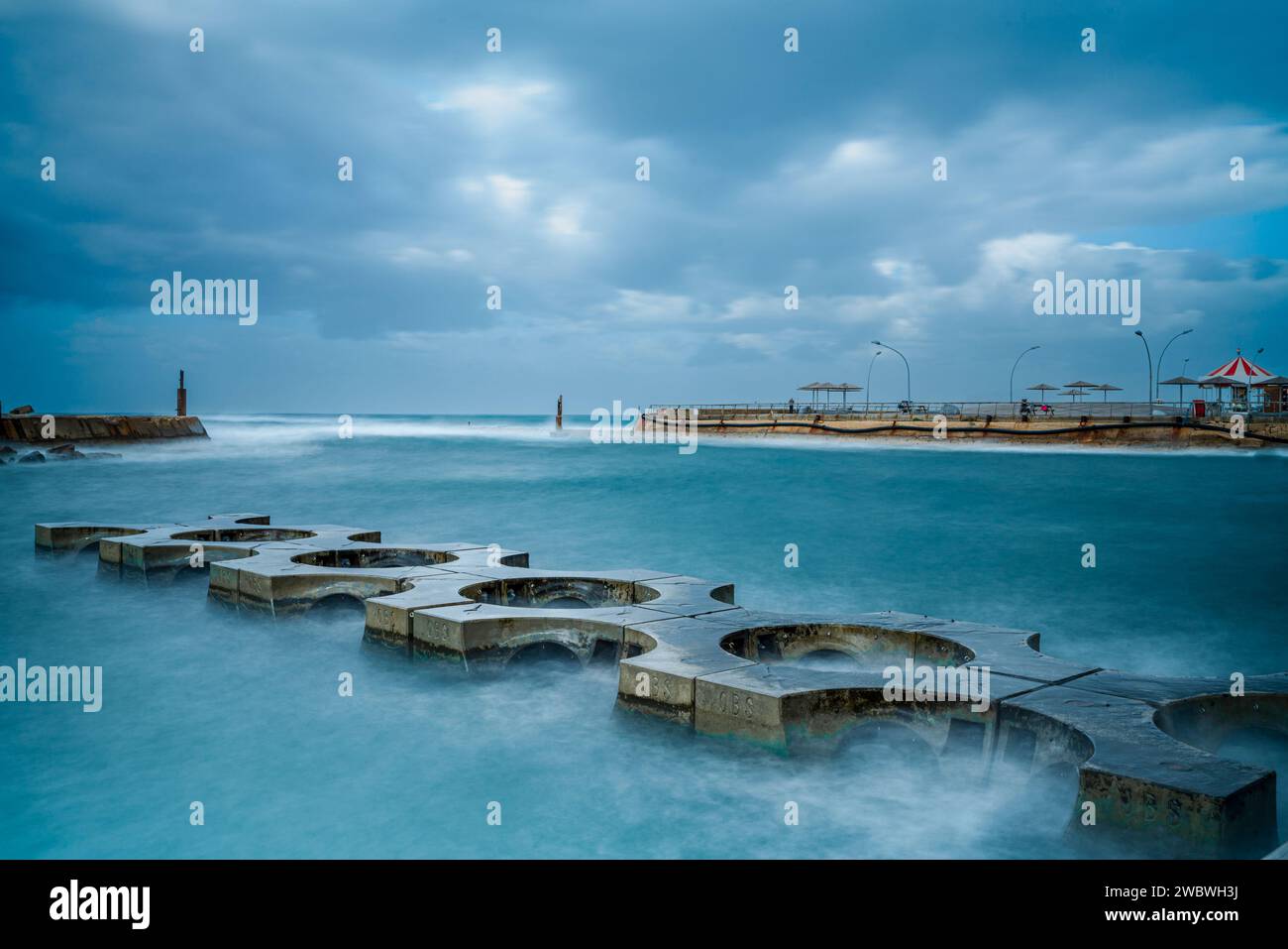 A picturesque breakwall positioned amidst the vastness of the ocean ...