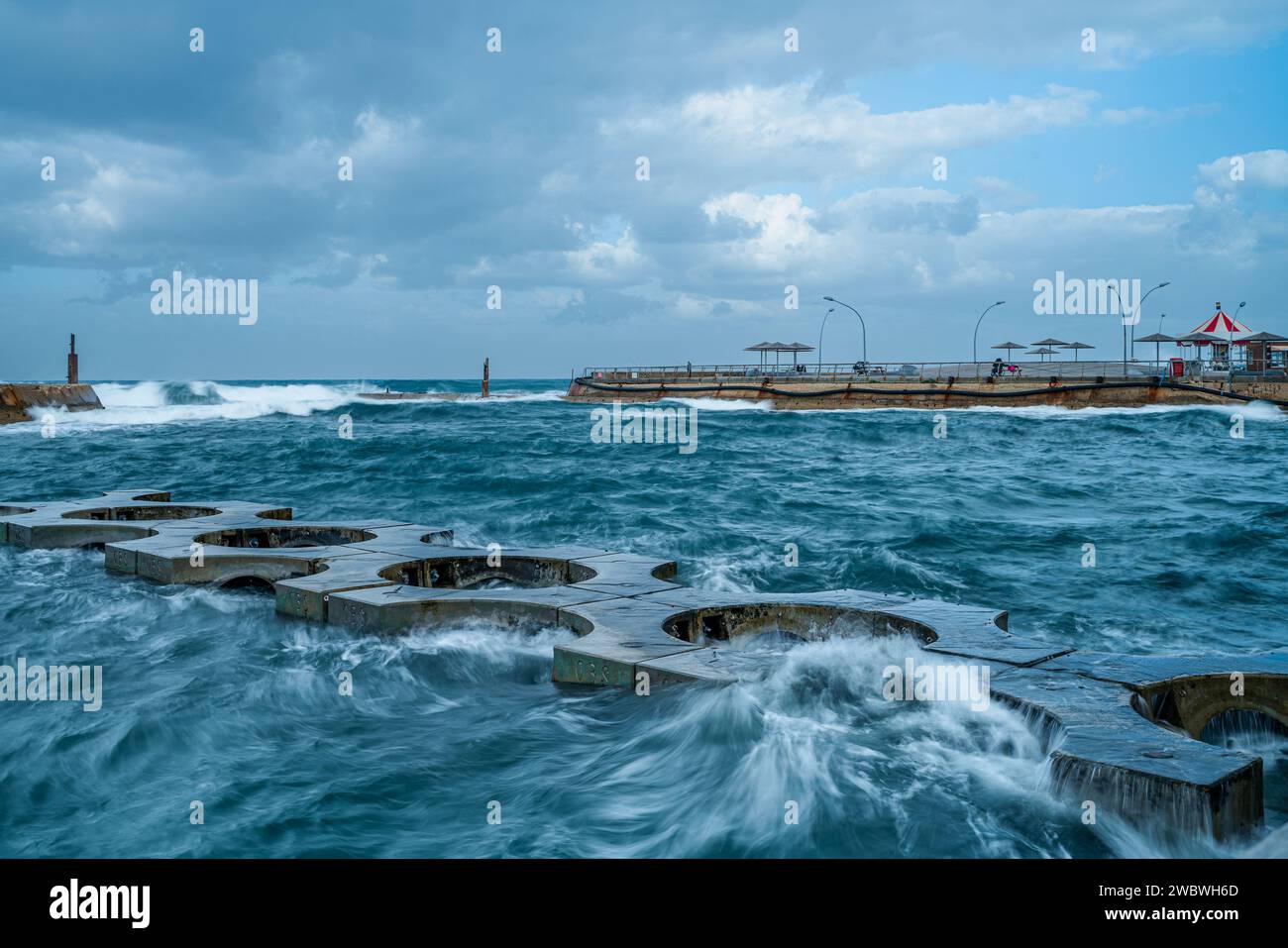 A picturesque breakwall positioned amidst the vastness of the ocean ...