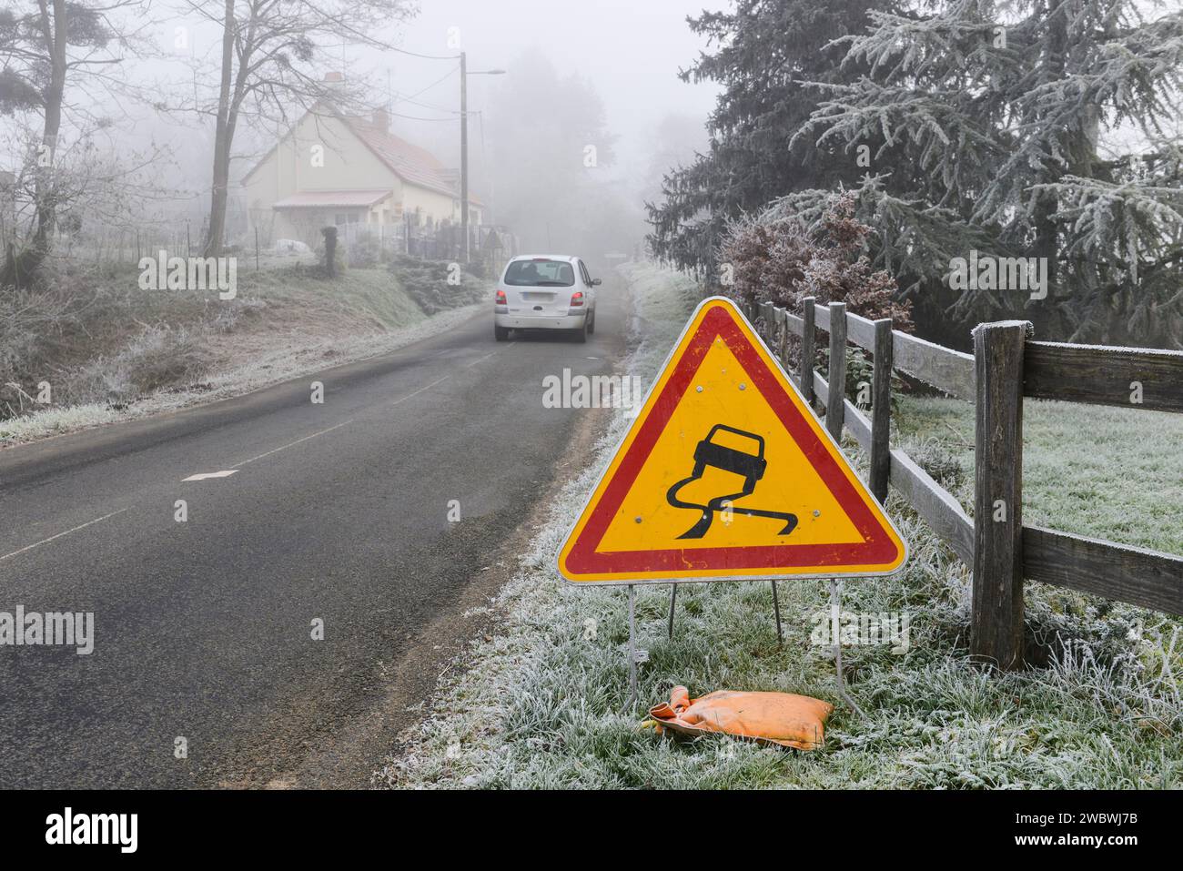 Roadside sign in icy conditions, indicating a risk of ice to cars Stock ...