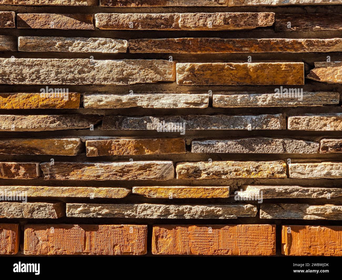 The masonry wall are made of gray wild flat stone and bricks. Side ...